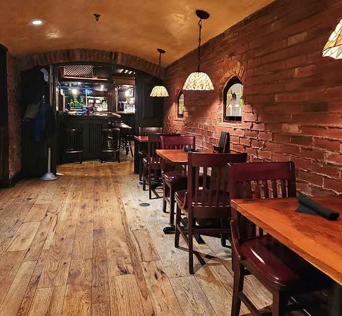 Exposed brick and warm wood create an atmosphere that feels both historic and inviting, perfect for settling in.