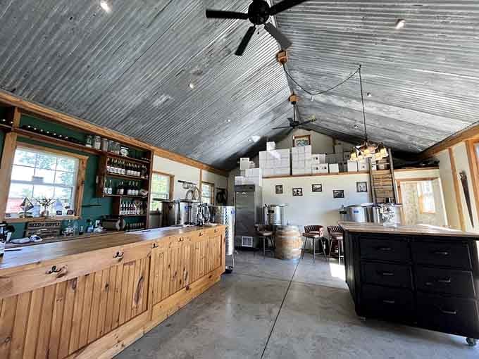 That corrugated metal ceiling and rustic wood bar create the kind of unpretentious charm Pottery Barn wishes it could bottle.