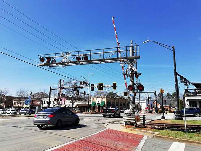 That vintage railroad crossing isn't just for show; it's a working reminder that some towns still have soul.