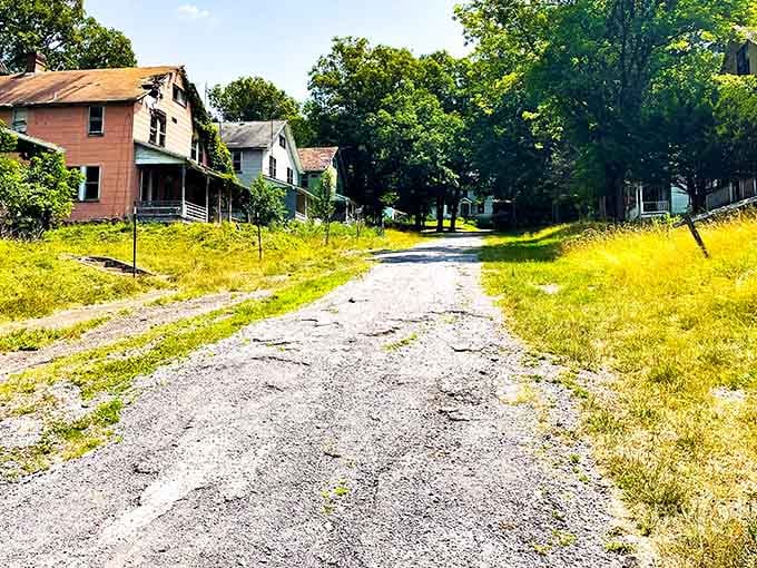 This cracked pathway once echoed with footsteps of workers heading home; now it's just you and the ghosts.