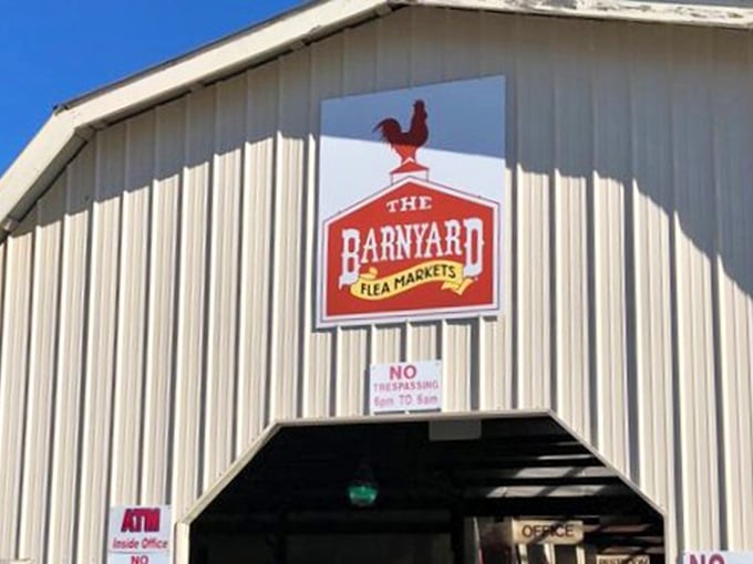 That cheerful red rooster perched above the entrance promises country charm and bargains waiting inside.