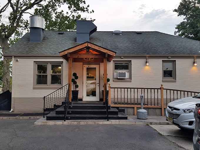 This charming cottage-style building with warm lighting promises cozy comfort and exceptional seafood just beyond that welcoming entrance.