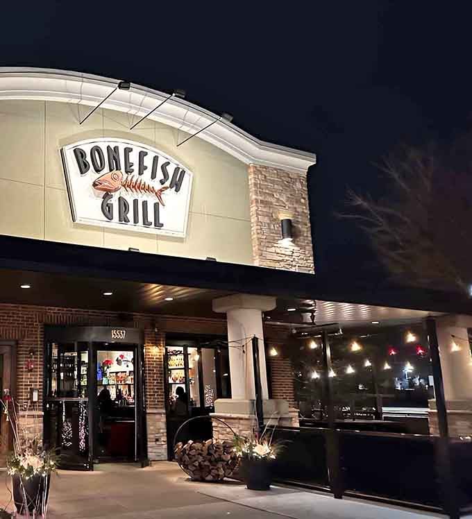 Evening lights glow warmly at Bonefish Grill, beckoning hungry diners toward wood-grilled perfection and coastal flavors.