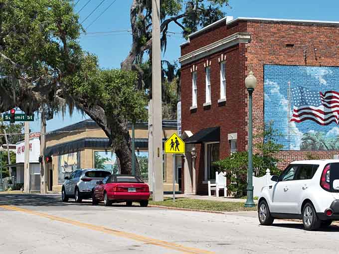Spanish moss and patriotic murals frame downtown streets where the lake beckons just beyond the buildings ahead.
