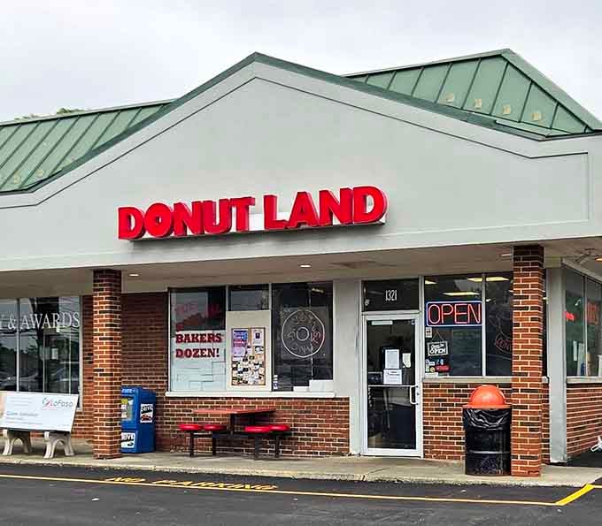 The green metal roof and classic brick exterior signal serious donut business happening inside this neighborhood treasure spot.