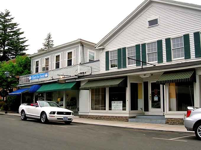 Classic white clapboard storefronts line up like a perfectly preserved postcard from a gentler era of American life.