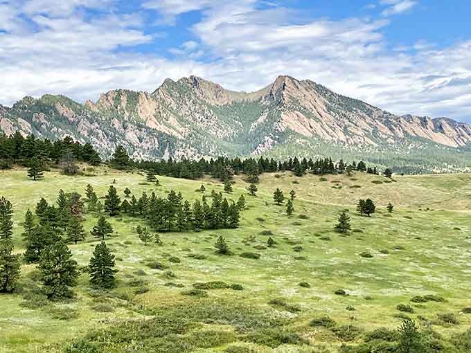 The Flatirons rise like ancient stone sentinels guarding Boulder, their tilted slabs creating drama against endless blue skies.