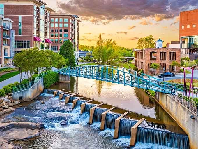 This blue bridge over cascading waterfalls proves Greenville turned its downtown river into pure urban magic.