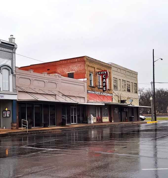 Rain-slicked streets and vintage architecture create a scene straight out of a classic film noir.