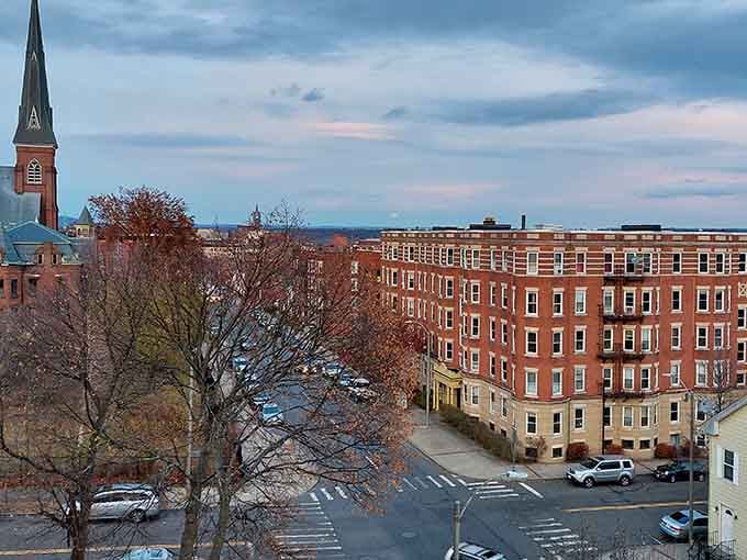 Historic brick buildings line these streets where mill workers once walked, now home to vibrant community life.