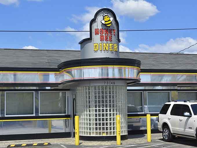 That cheerful bee mascot and gleaming chrome facade promise comfort food with a smile waiting inside.