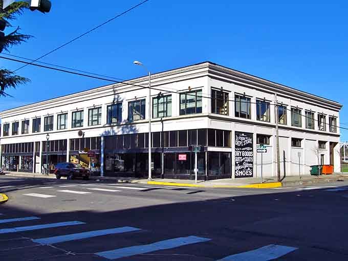 This corner building stands proud like a ship's bow, anchoring downtown with windows that have watched generations pass.