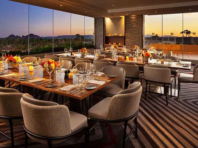 Floor-to-ceiling windows frame desert sunsets while you savor every tender, juicy bite of steak.