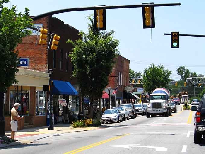 Main Street comes alive with traffic lights, parked cars, and brick storefronts lining both sides perfectly.
