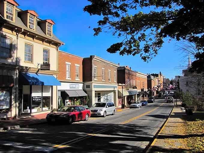 Historic storefronts line this charming street where autumn leaves remind you why small towns matter so much.