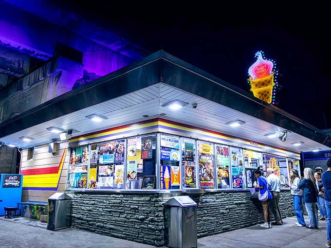 That glowing neon cone beckons like a lighthouse for ice cream lovers navigating Pittsburgh's nighttime streets.