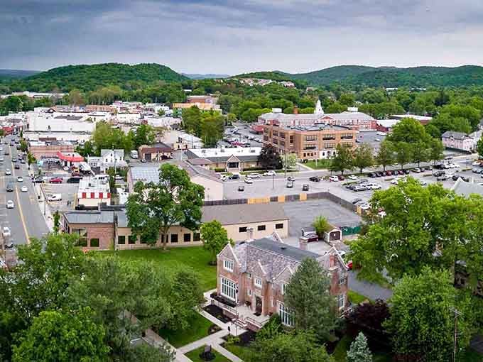 Green hills embrace this charming downtown where church steeples pierce the sky like postcards from simpler times.