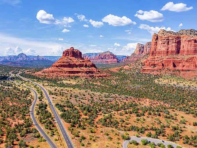 Red rocks rising against endless blue sky create a view so stunning it belongs on a postcard from Mars.