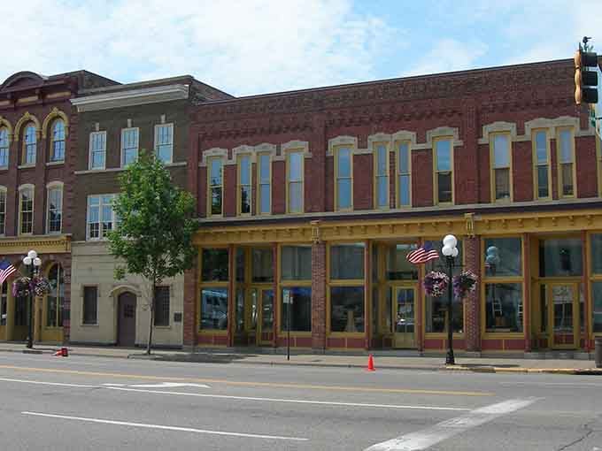 Historic storefronts wear their age gracefully, with tall windows that have watched generations stroll these sidewalks.