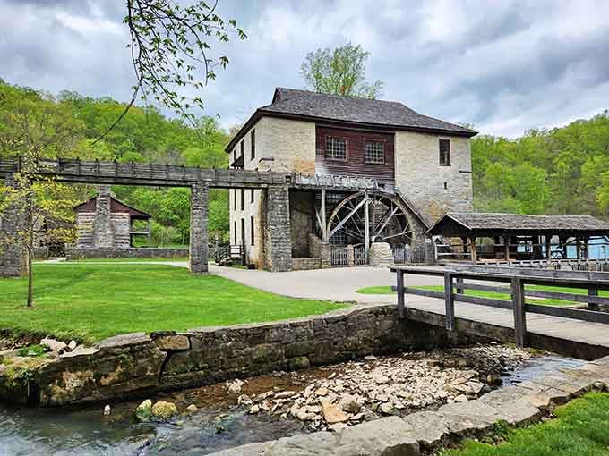 That massive wooden waterwheel still turns like it's 1817, grinding corn and grinding away our modern worries.