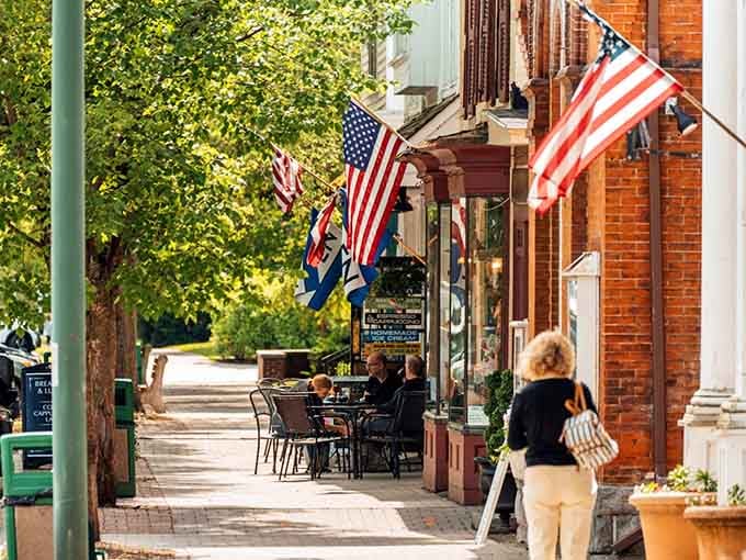 Morning coffee tastes better when you're sipping it on a brick sidewalk beneath fluttering flags and historic storefronts.