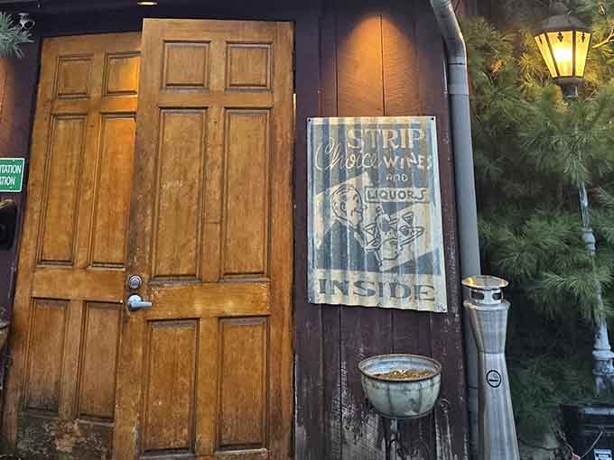 That weathered wooden door whispers secrets of perfectly charred steaks waiting just beyond the threshold inside.