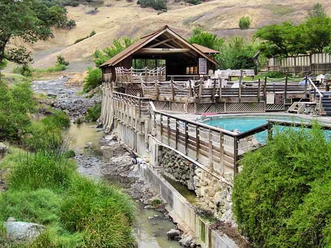 This rustic hillside retreat looks like something from a Western movie, but the warm water is gloriously real.