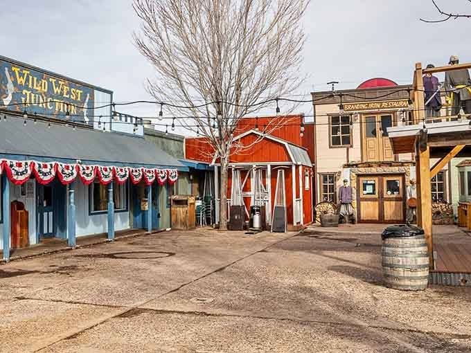Patriotic bunting drapes across storefronts in this charming corner where the Old West meets small-town America perfectly.