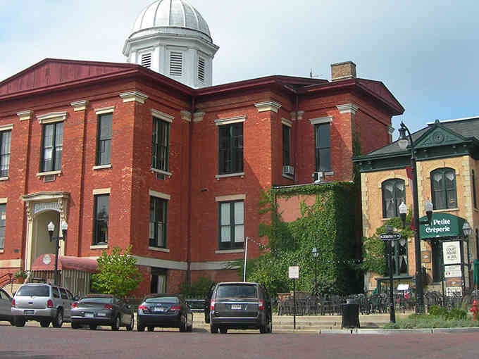 That red brick courthouse with its white dome commands attention like a wedding cake at a potluck dinner.