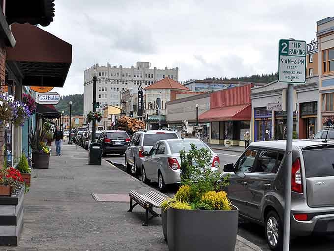 Flower baskets and mountain views frame this street scene better than any Hollywood set designer could.