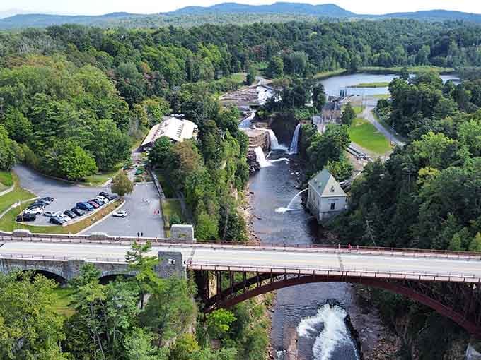 From above, the chasm reveals its full glory with waterfalls, forests, and mountains stretching toward the horizon.