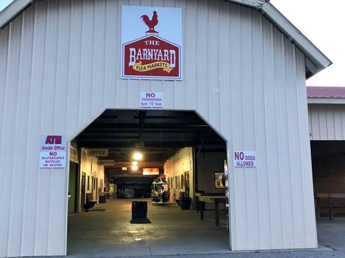 Evening light glows warmly through the barn entrance, beckoning shoppers to discover what treasures await within.