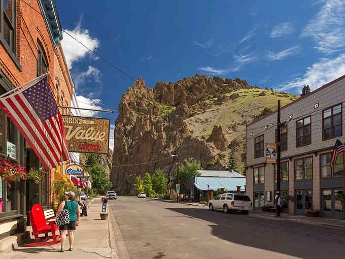 That American flag and vintage signage tell you Creede's proud history runs as deep as the canyon it calls home.