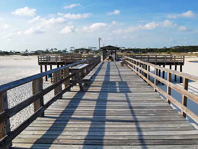 That fishing pier stretches toward the horizon like a wooden highway to complete tranquility.