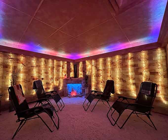 That fireplace centerpiece surrounded by zero-gravity chairs proves relaxation can be both therapeutic and absolutely stunning.