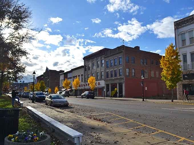 Golden autumn banners flutter above streets where community spirit runs deeper than the nearby rivers ever could.