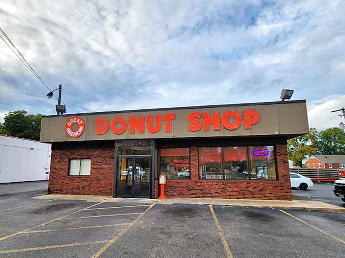 The neon "OPEN" sign glowing against that brick exterior is like a beacon calling all sugar lovers home.