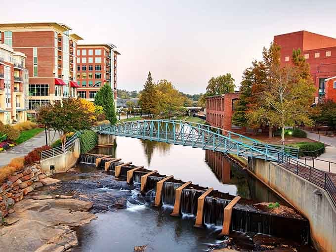 Autumn colors frame the flowing water where modern city planning meets natural beauty in perfect harmony.