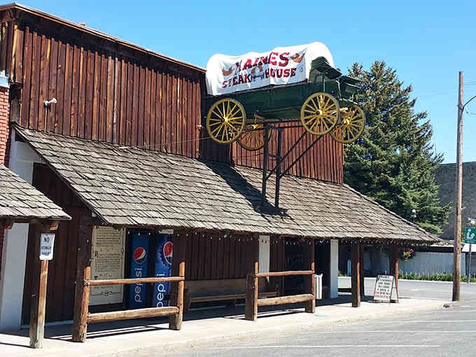 Under bright blue skies, this frontier steakhouse stands proud with its wagon-topped roof beckoning hungry travelers inside.