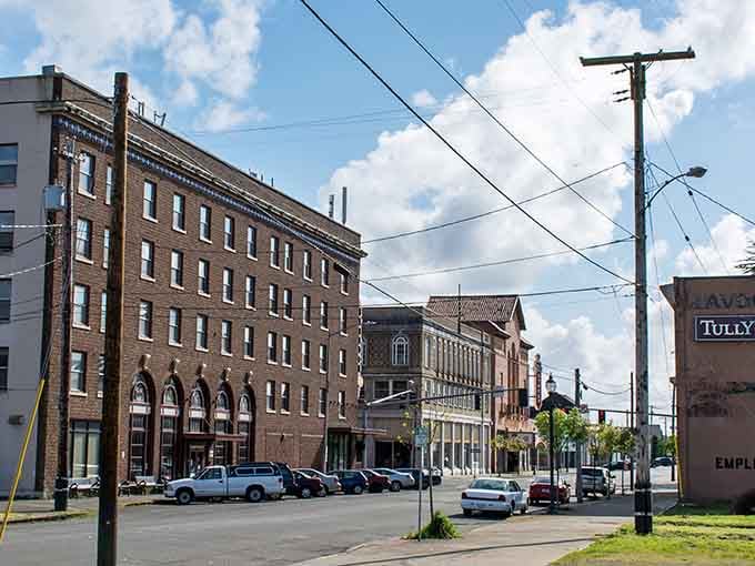 Brick warehouses tell stories of timber days, their solid walls holding memories like your grandmother's photo albums.