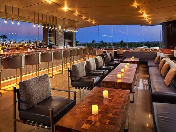 The sleek bar glows with warm light, setting the stage for an unforgettable evening of dining.