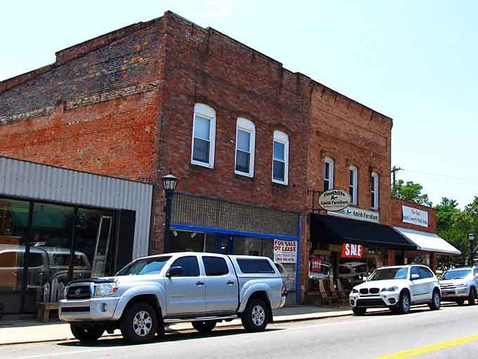 Weathered brick buildings stand shoulder-to-shoulder, their windows watching decades of stories unfold below them.