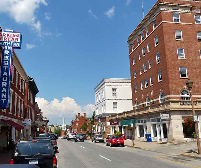 Classic architecture meets everyday life on this main street where church steeples still define the skyline beautifully.