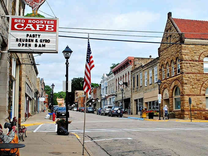 The Red Rooster Cafe's vintage sign beckons hungry travelers while Old Glory waves above this perfectly preserved main street scene.