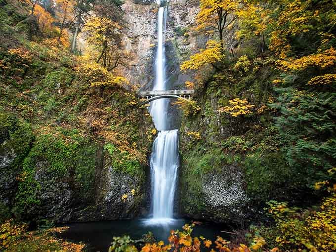 The elegant stone bridge spans the falls perfectly, proving that sometimes the best views require zero effort.