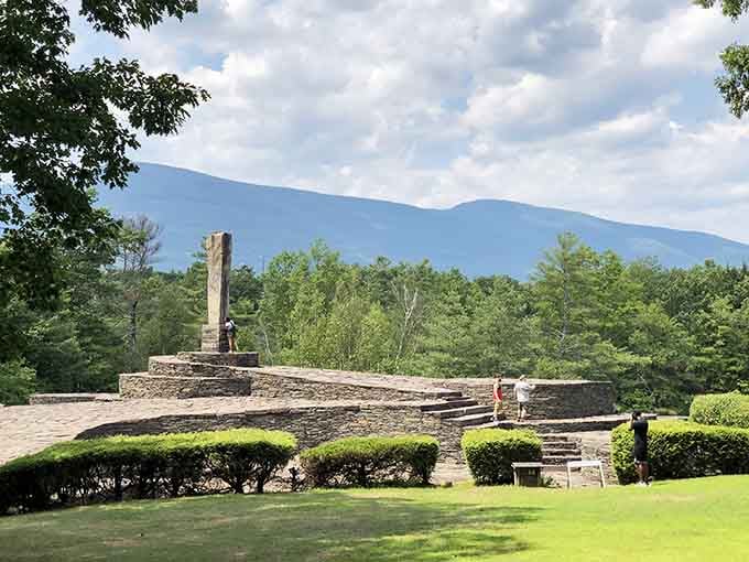 Those perfectly manicured shrubs frame the stone terraces like nature's own punctuation marks against the dramatic Catskill Mountain backdrop beyond.
