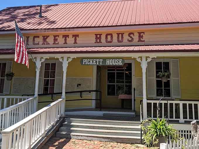 The red roof and white railings frame an entrance where family-style feasts have been served for generations.