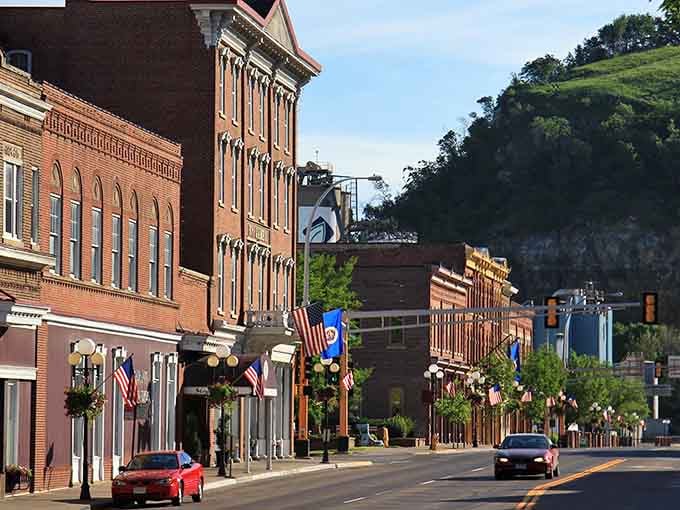 That dramatic bluff rising behind downtown makes every street view look like a postcard come to life.