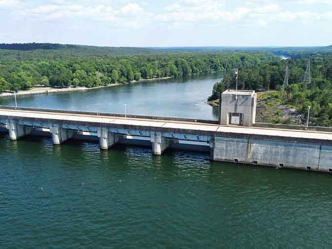Where engineering meets natural beauty, this dam stretches across turquoise waters surrounded by endless forest horizons.