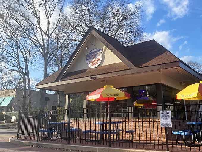 Those bright blue picnic tables and cheerful umbrellas create the perfect summer scene for enjoying authentic Chicago-style dogs.